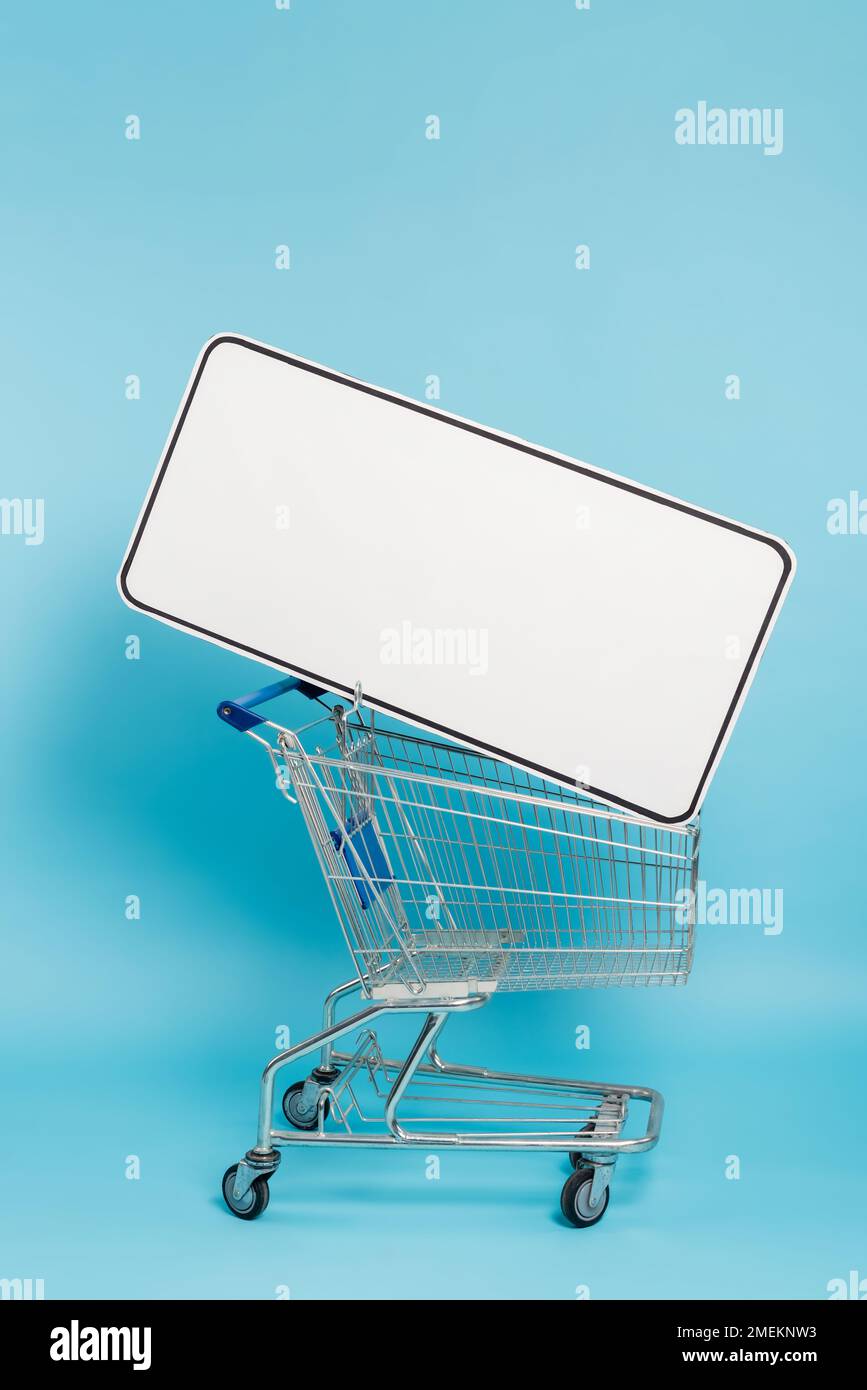 shopping cart with huge template of mobile phone on blue background ...
