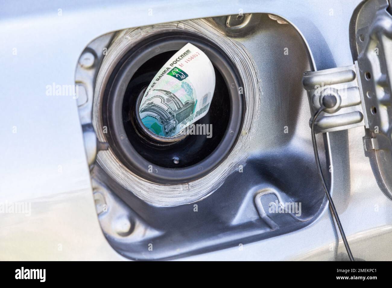 Russian roubles banknotes in the gas tank of a vehicle. Concept photo ...