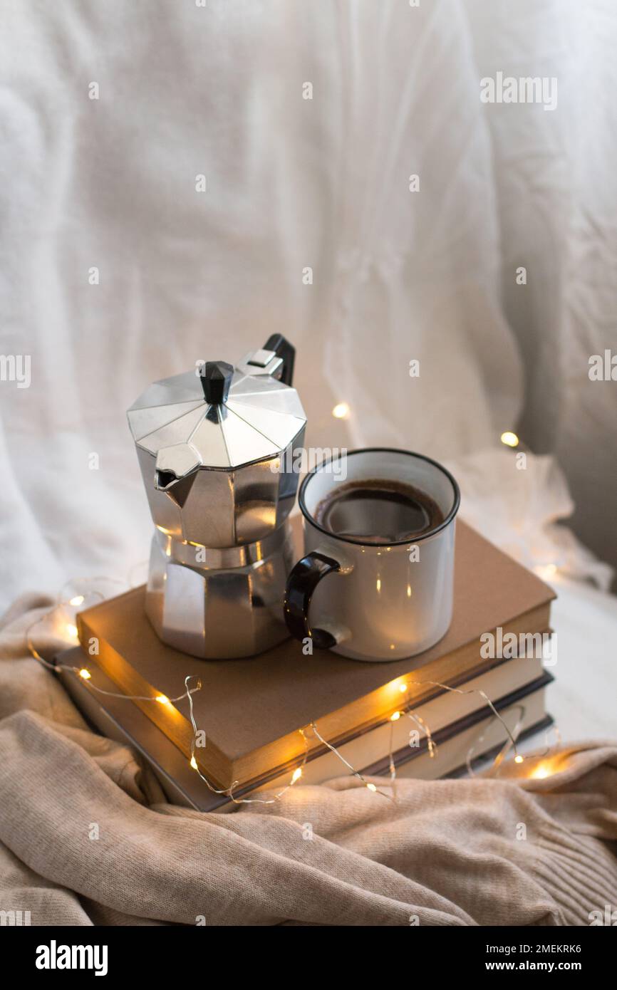 A moka pot end a cup of coffee in a cozy holiday environment. Enjoying ...