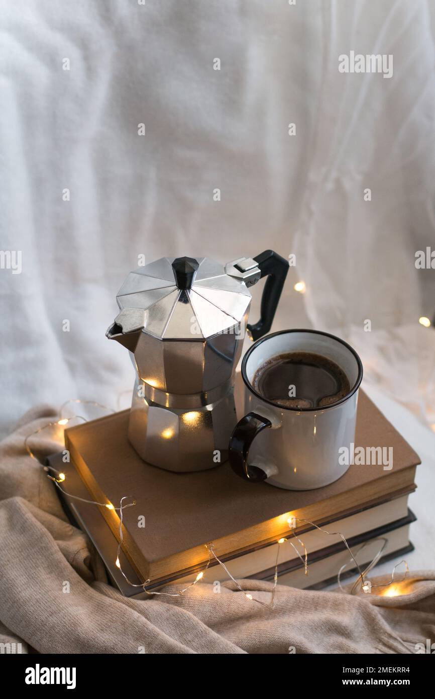 A moka pot end a cup of coffee in a cozy holiday environment. Enjoying ...