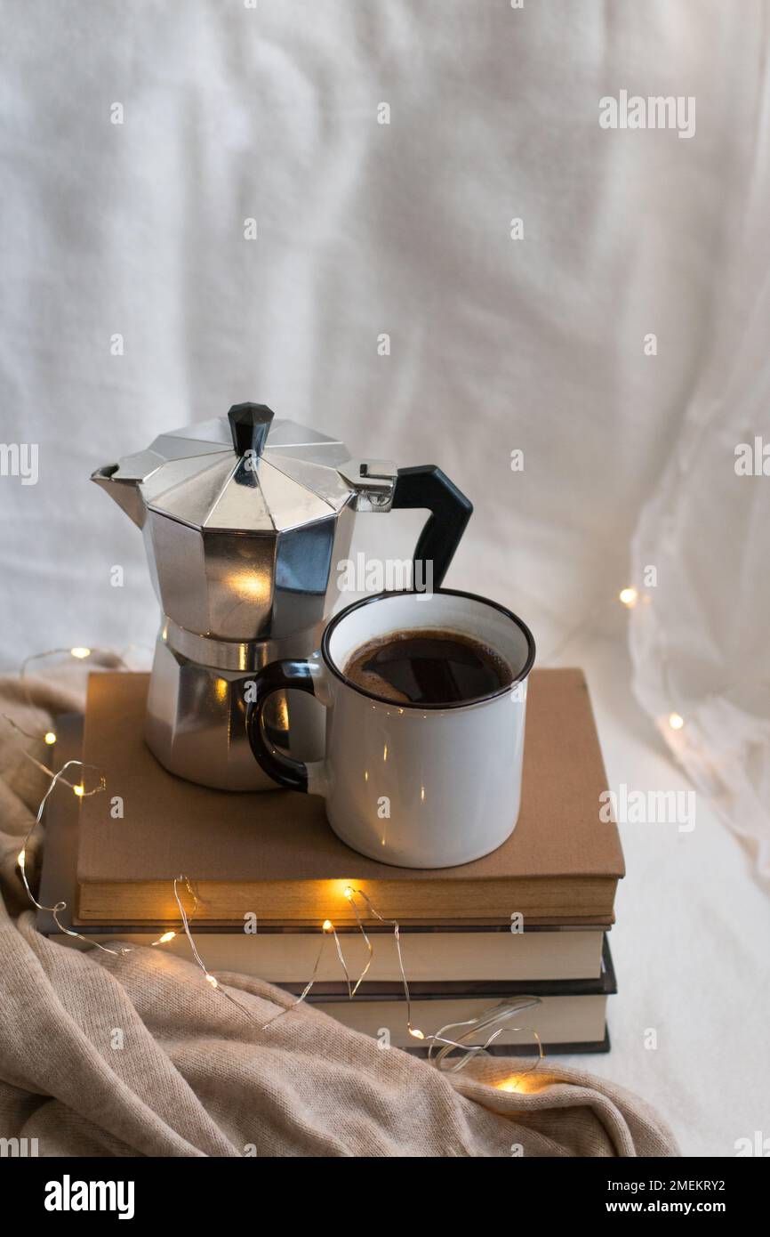 A moka pot end a cup of coffee in a cozy holiday environment. Enjoying ...