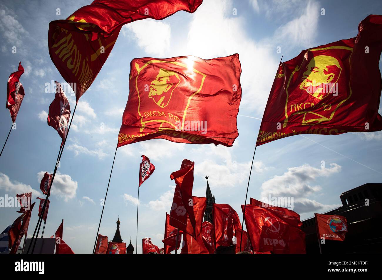 Russian communist supporters hold their flags with portraits of ...