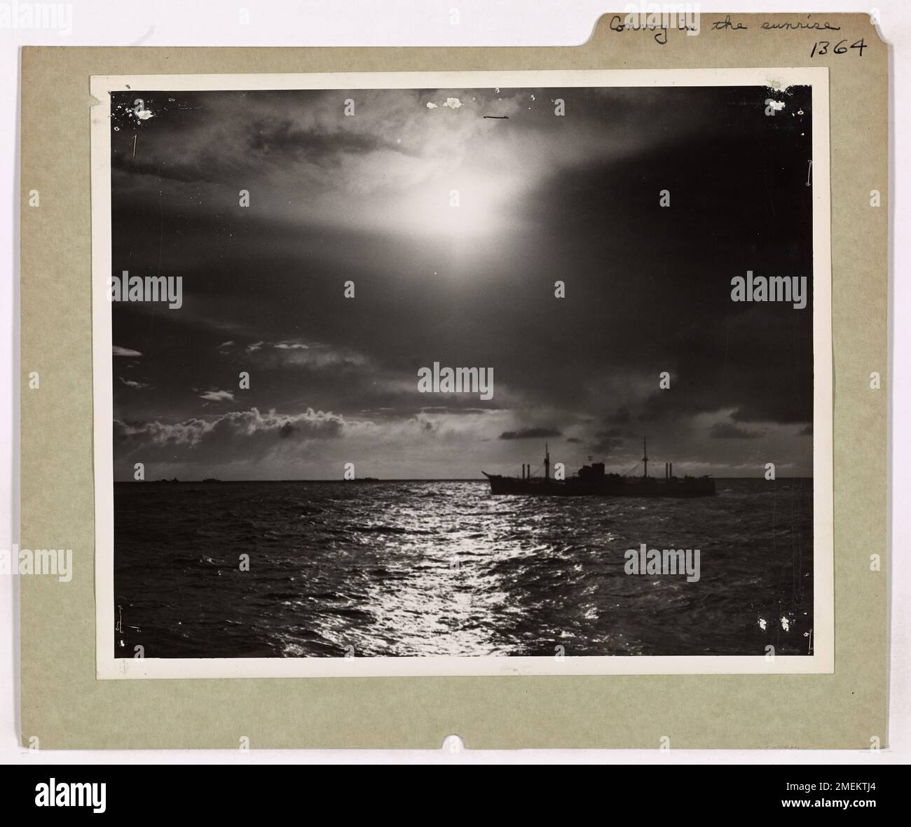 A convoy of military vessels is seen at sunrise, with the soft light ...