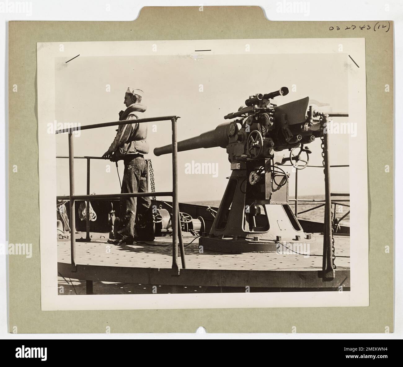 A U.S. Coast Guard gunner is seen manning his gun, likely during a ...