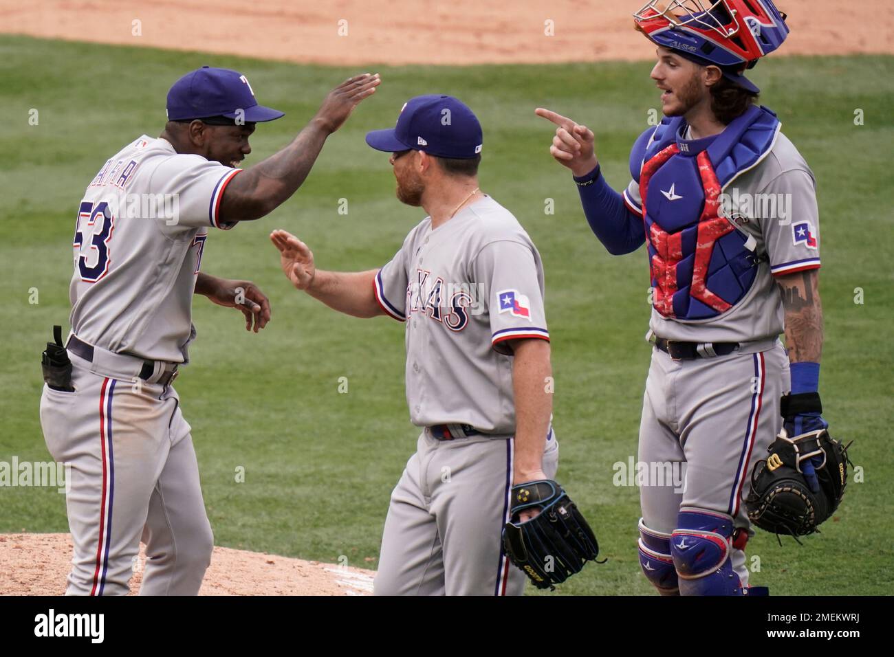 Texas Rangers' Adolis Garcia, from left, relief pitcher Ian Kennedy and ...