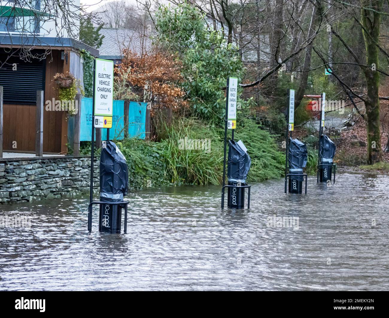 Electric car charging points in a carpark underwater after torrential ...