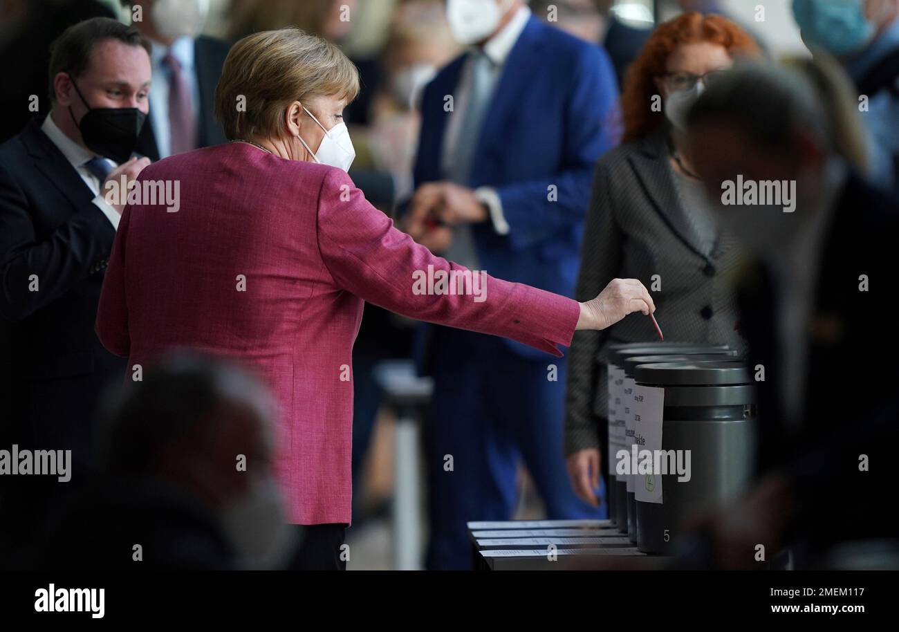 German Chancellor Angela Merkel casts her vote during a meeting of the ...