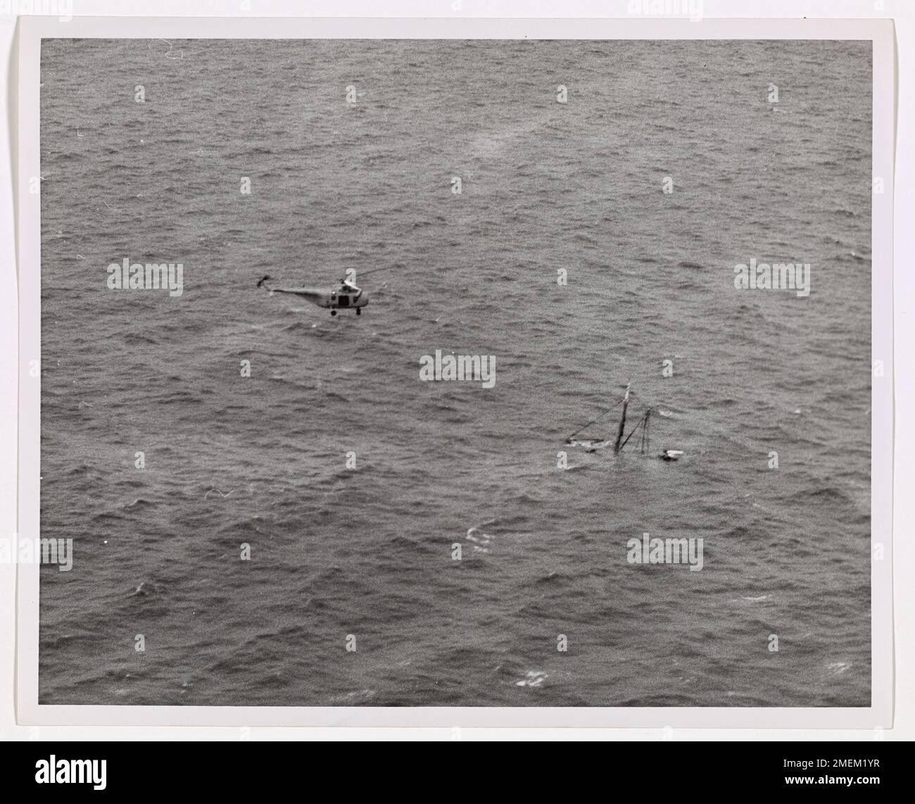 Coast Guardsmen perform a rescue operation to save two sailors stranded ...