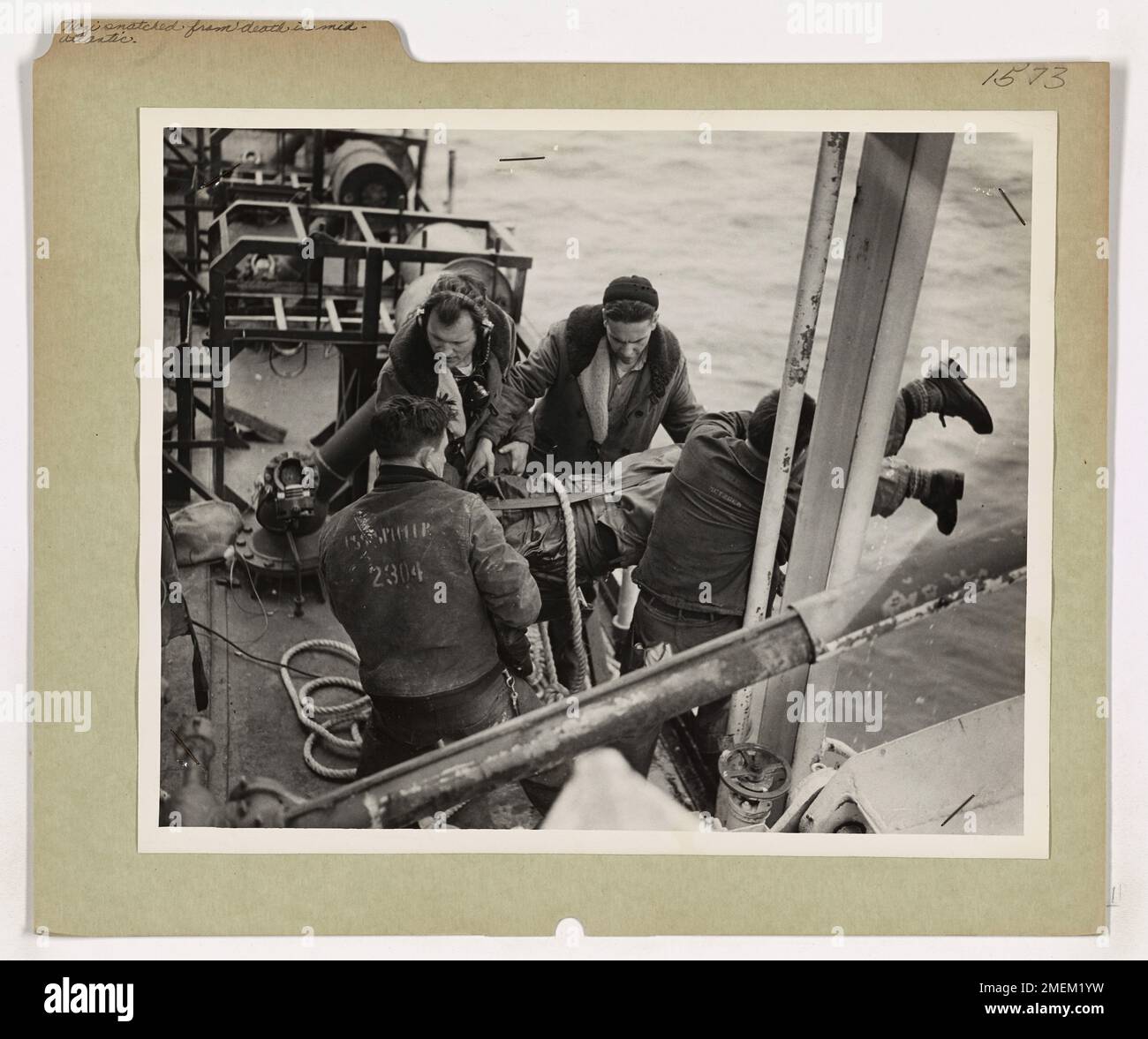 A captured German sailor is pulled aboard a U.S. Coast Guard cutter ...
