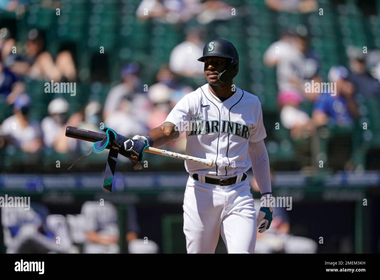 Seattle Mariners' Kyle Lewis hands off his bat after walking against ...