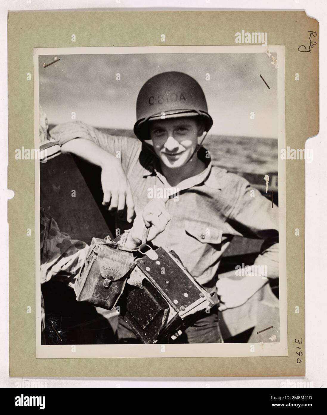Ken Riley, a Coast Guard combat artist, stands after winning an award ...