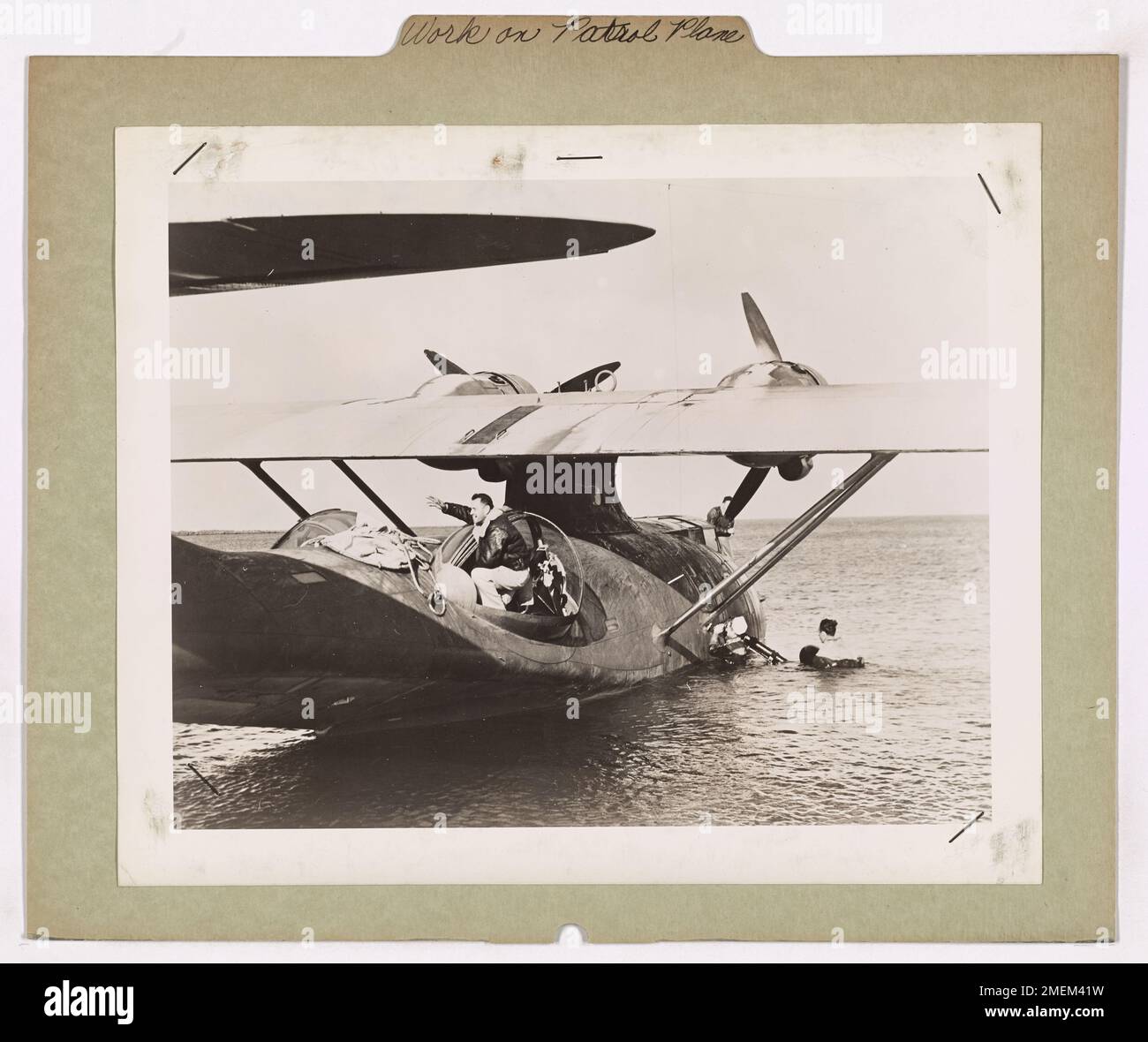 Coast Guard aviators perform maintenance on a patrol plane. This ...