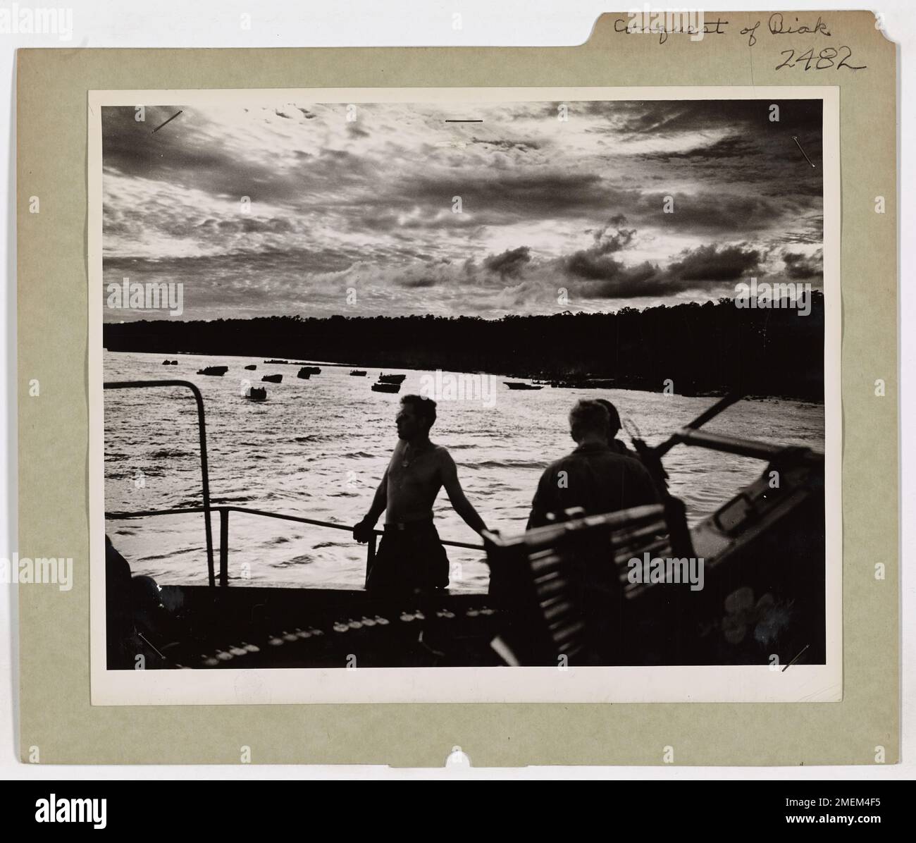 Coast Guardsmen aboard an LST stand ready as American forces land on ...