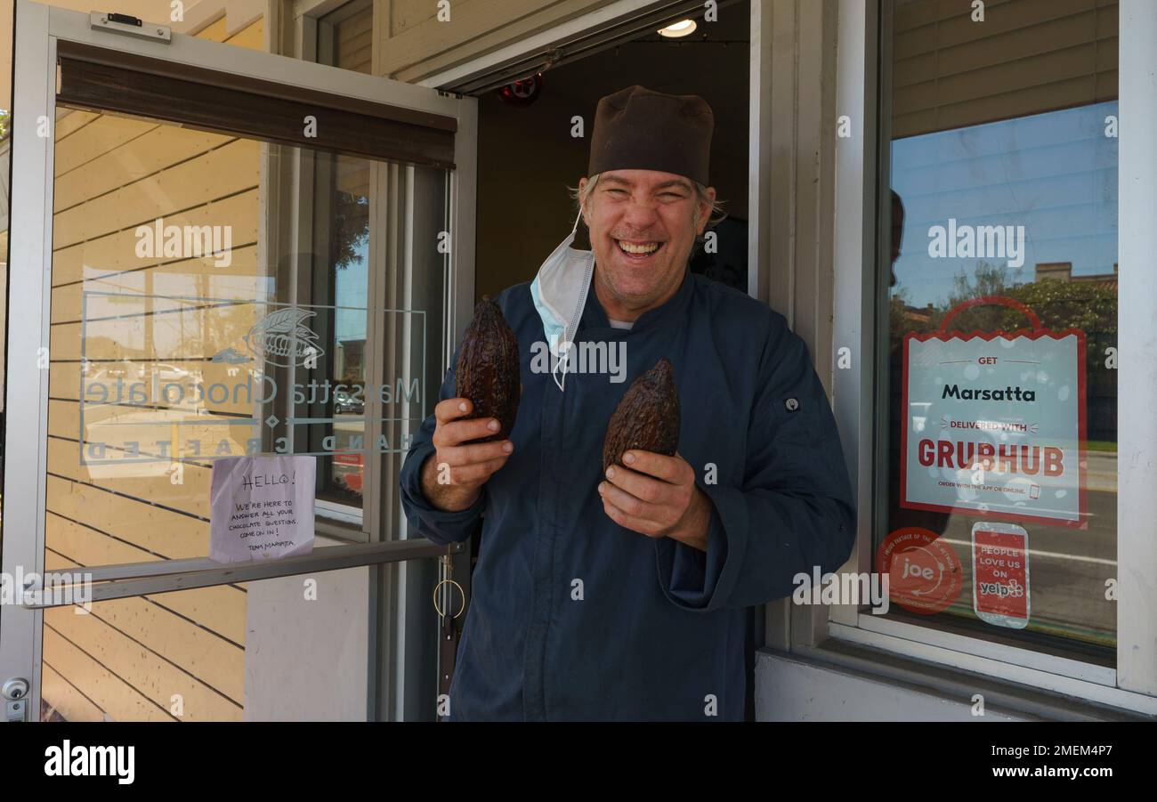 Jeffray Gardner, the owner of Marsatta Chocolate holds cacao fruit pods ...
