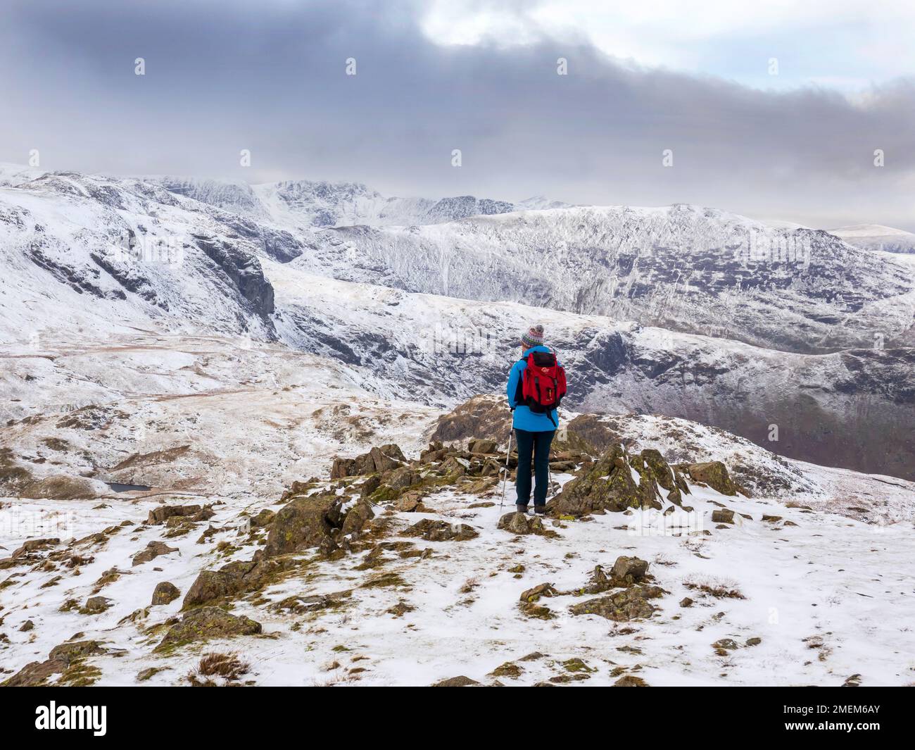 The Helvellyn range from Red Screes, Lake District, UK with a female ...