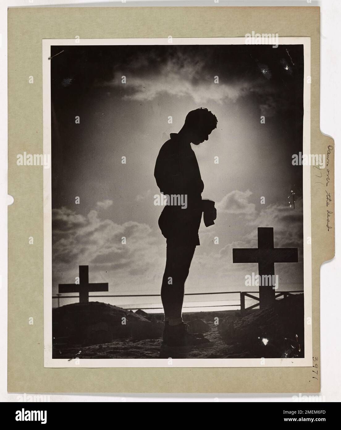 A Coast Guardsman stands in silent reverence at a Pacific island ...