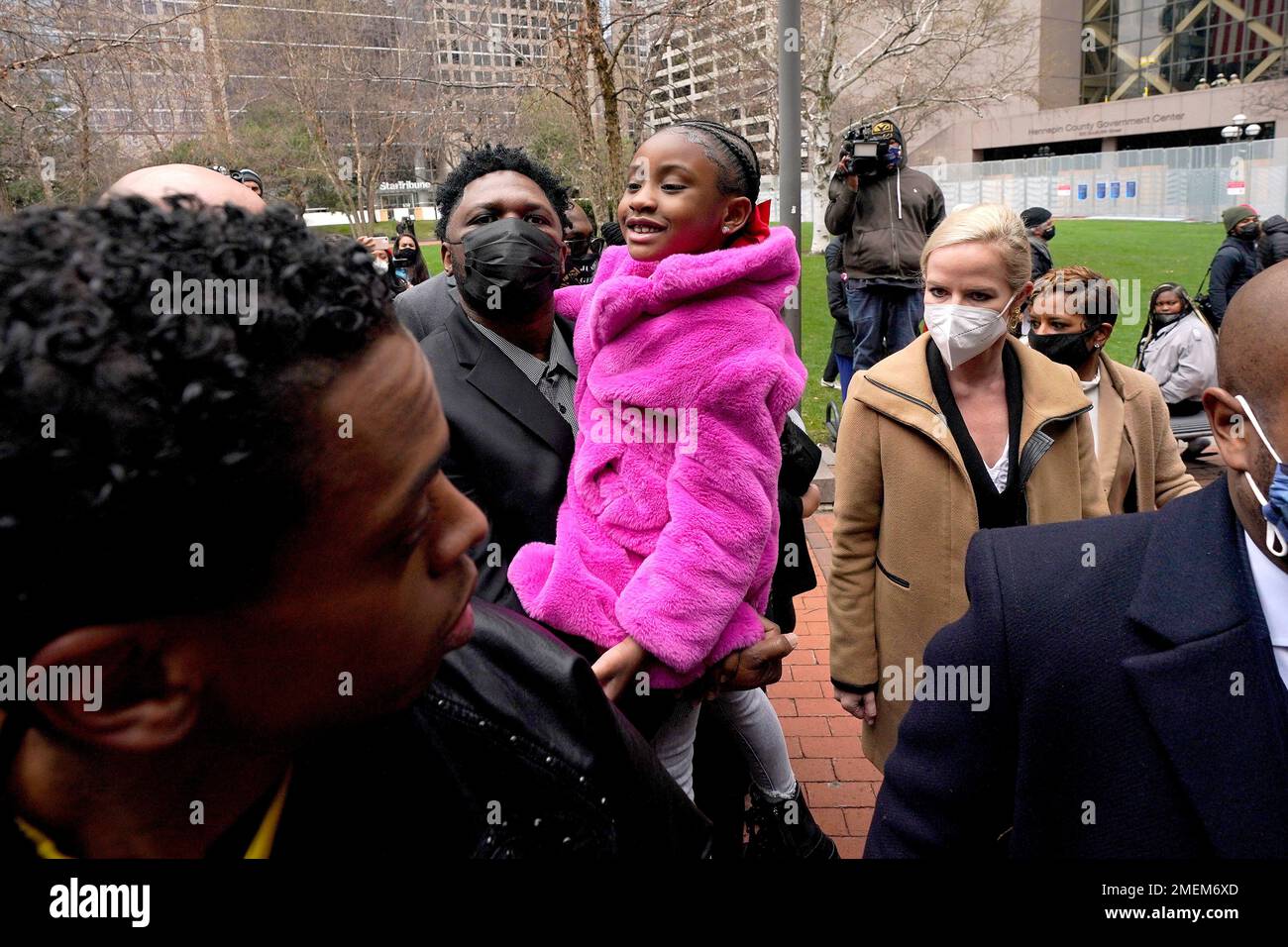 Gianna Floyd, center, the daughter of George Floyd, is carried while ...