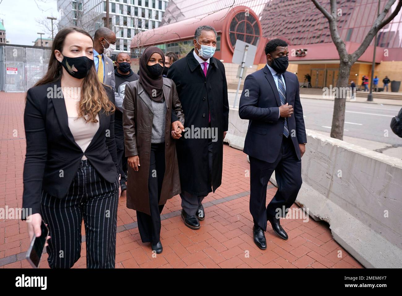 U.S. Rep. Ilhan Omar, D-Minn., center left, holds hands with Rev. Jesse ...