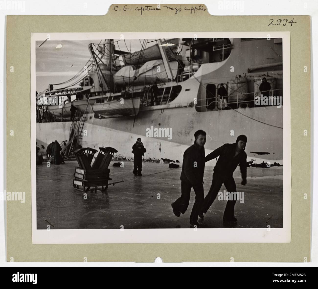 Coast Guard personnel deliver captured Nazi supplies, seized from a ...