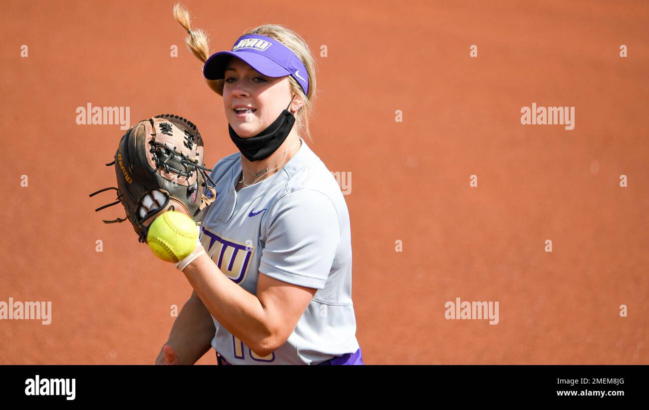 James Madison's, Madison Naujokas, throws the ball to first base during ...