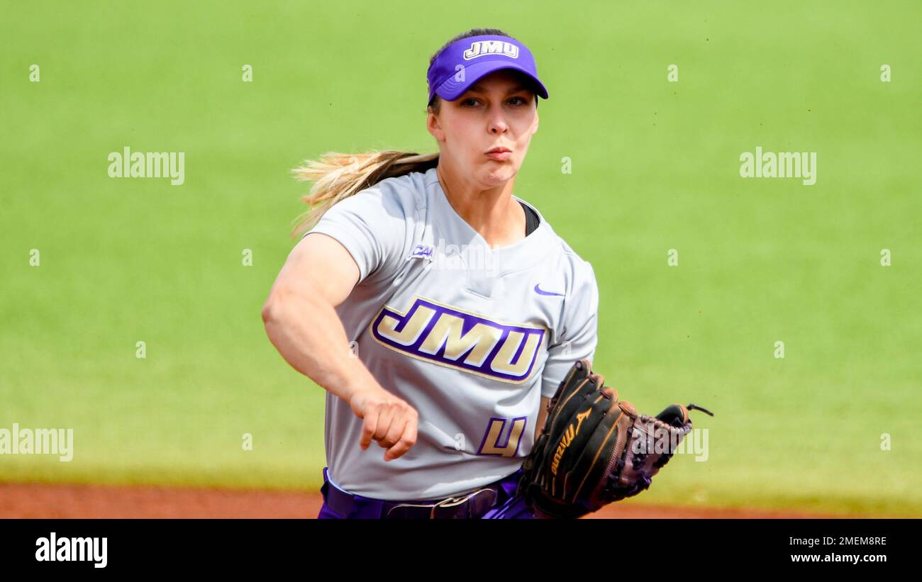 James Madison's Sara Jubas throws the ball to first base during an NCAA ...