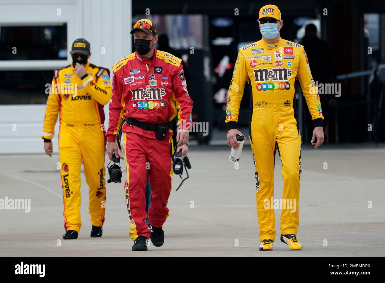 Kyle Busch, right, walks to his car prior to the start of the NASCAR ...