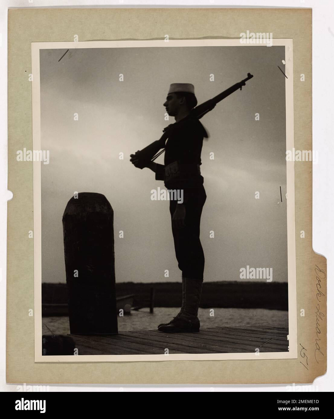 A Coast Guard member stands as part of the dock guard detail, ensuring ...