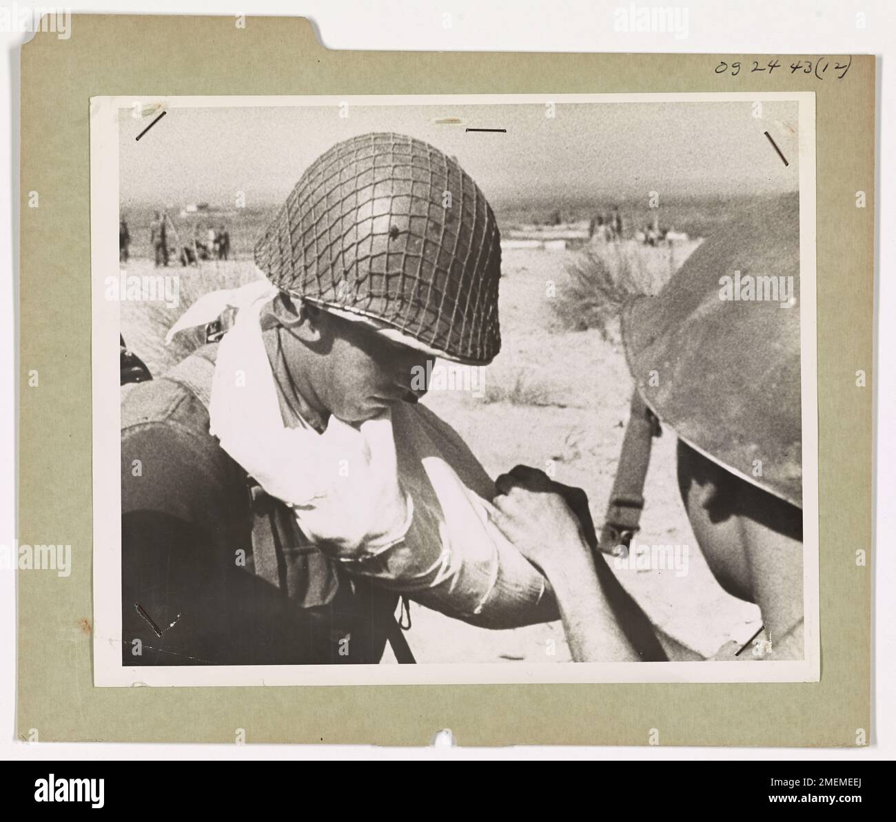 A medic provides treatment to a wounded soldier during combat, offering ...