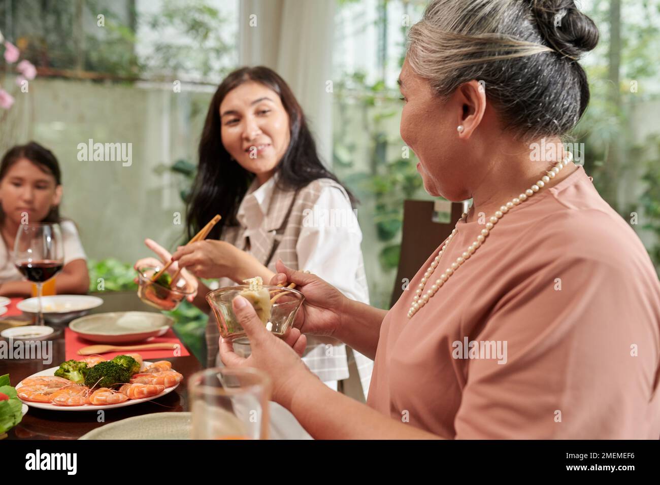 Happy family eating traditional dishes at Tet celebration at home Stock ...