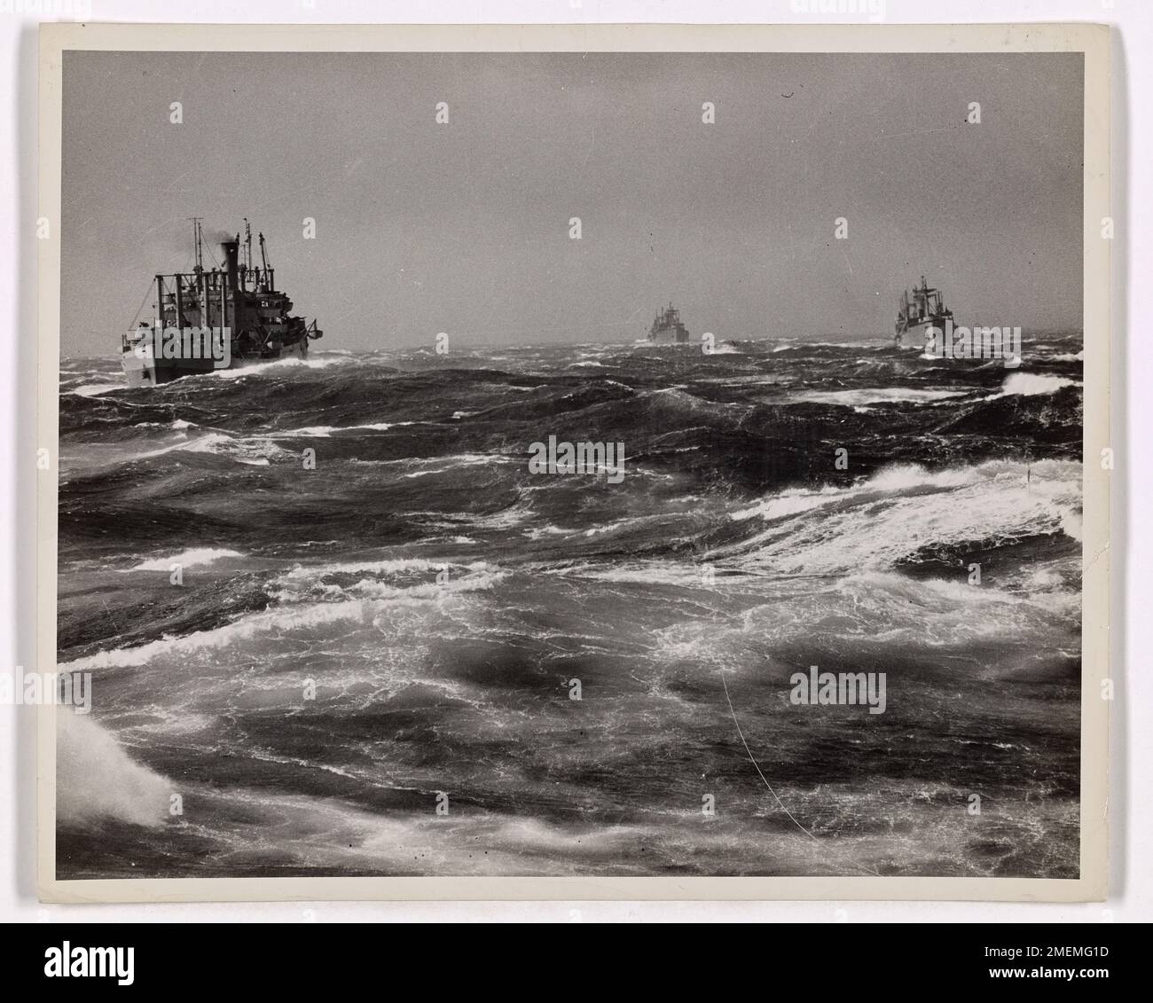 Ships from a Europe-bound convoy navigate through heavy seas and strong ...
