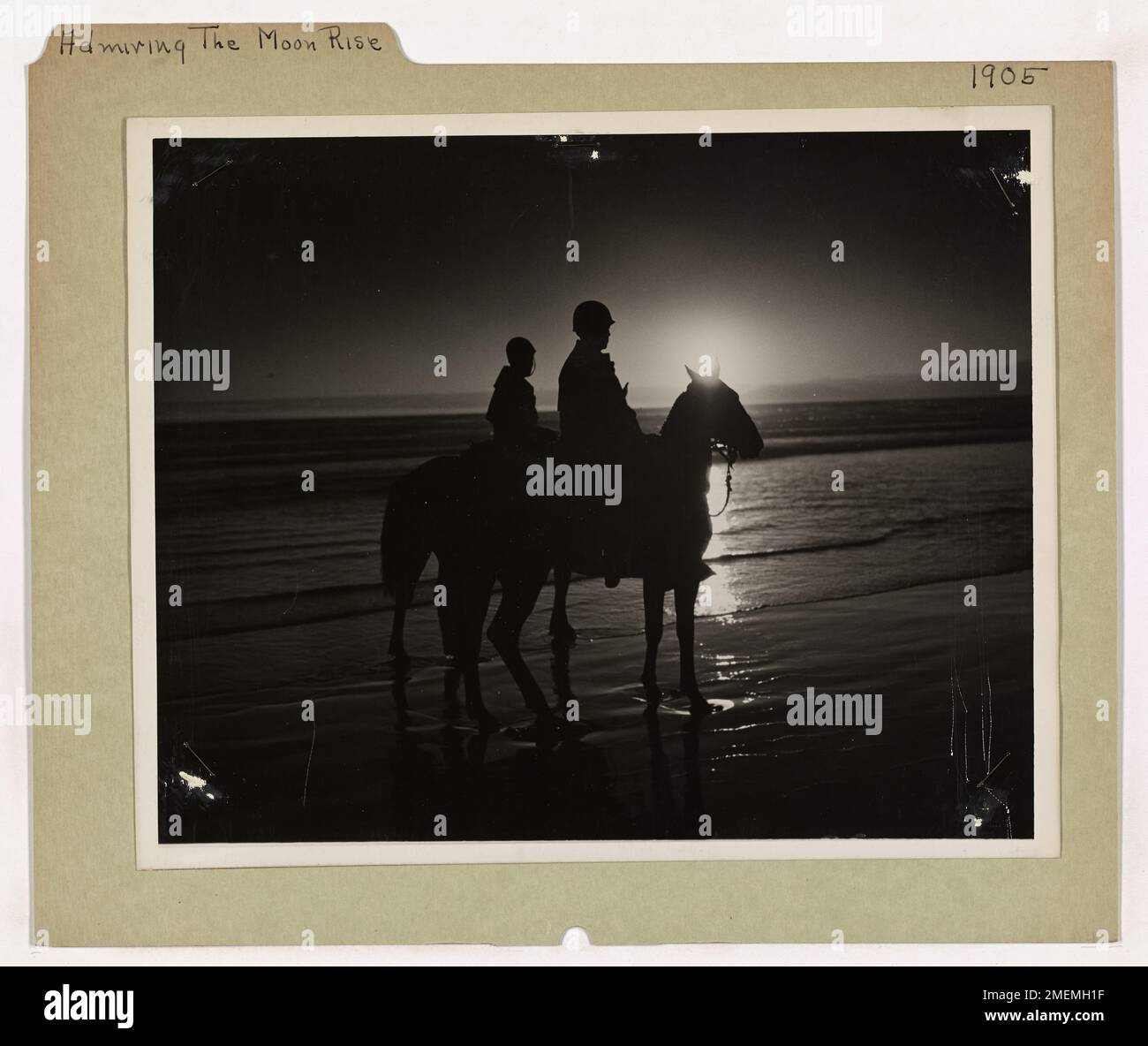Two Coast Guardsmen on mounted beach patrol take a moment to admire the ...