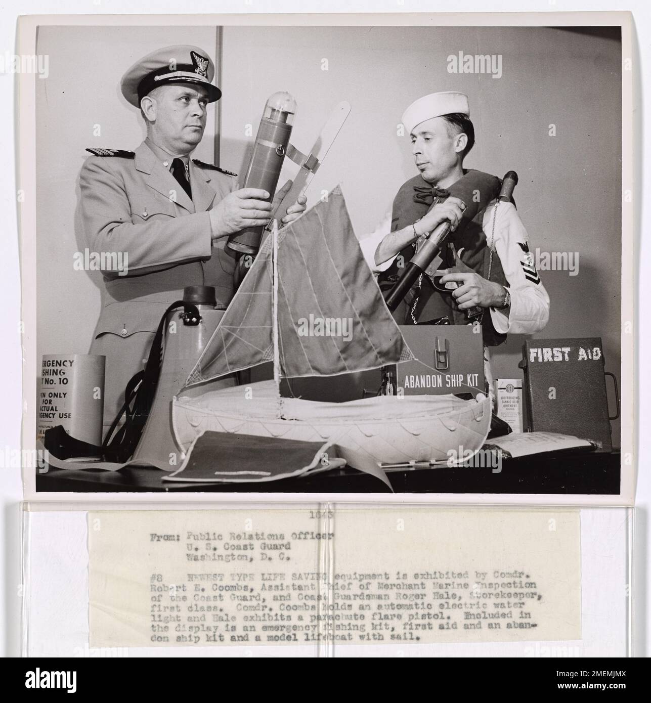 Commander Robert E. Coombs and Coast Guardsman Roger Hale display the ...