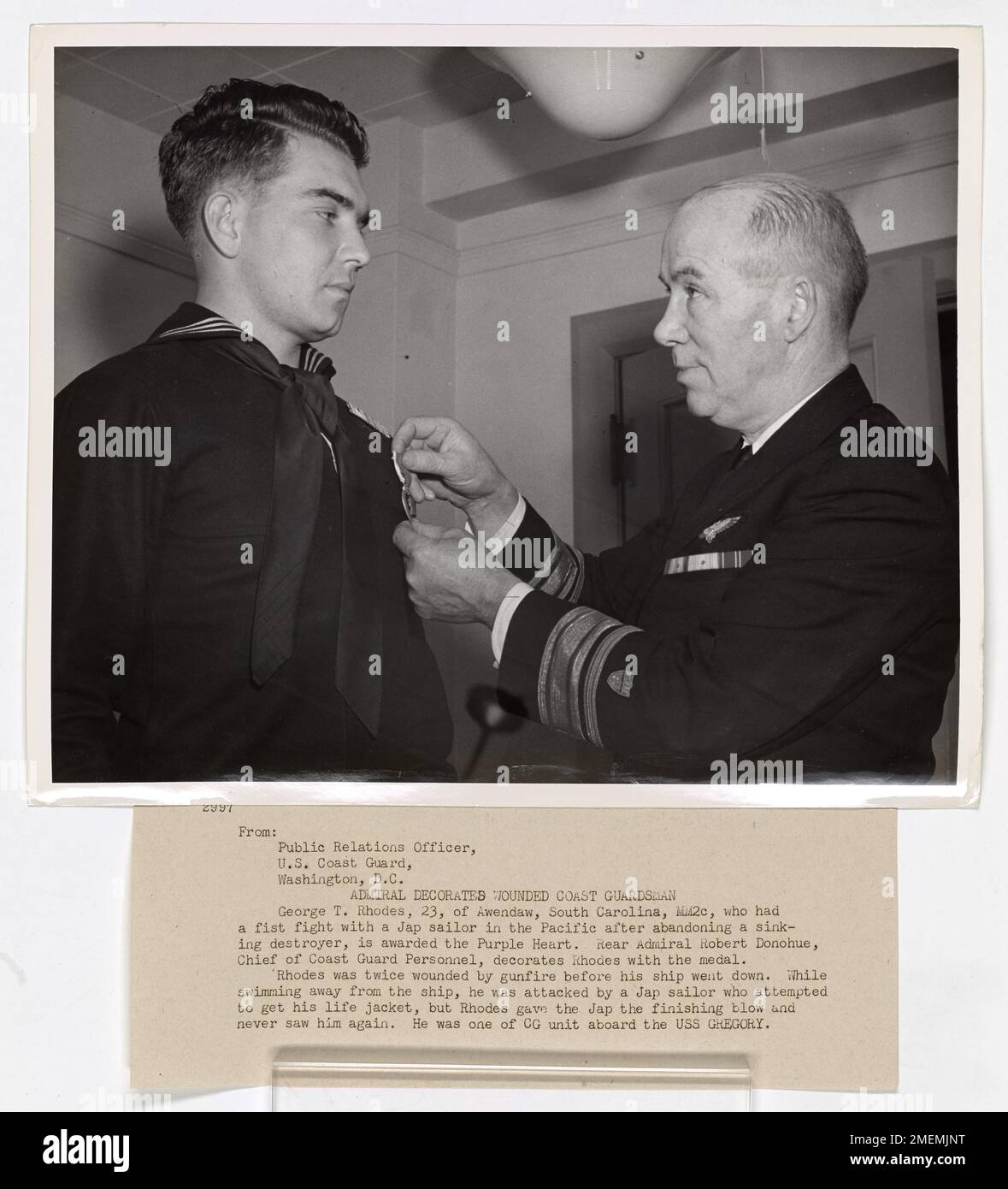 George T. Rhodes, a Coast Guardsman wounded in the Pacific, receives ...