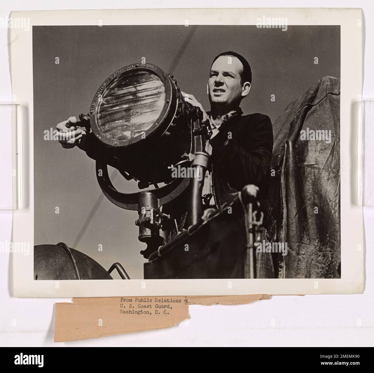 A U.S. Coast Guard operator uses a Carlisle & Finch searchlight in an ...
