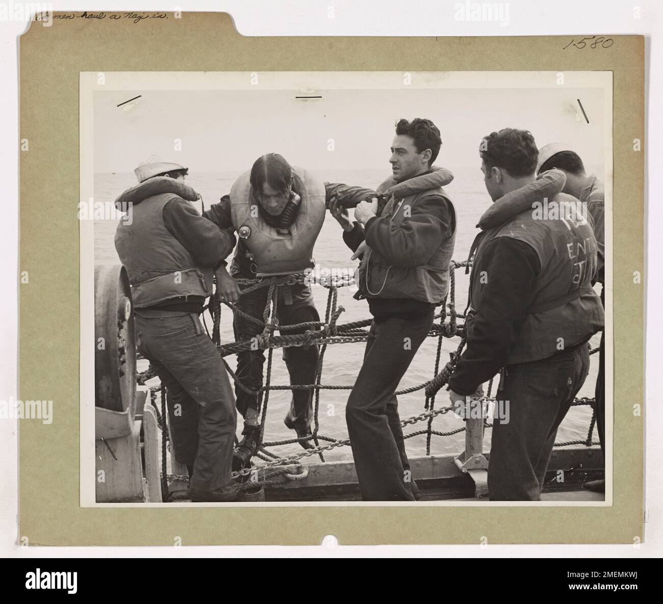 Coast Guardsmen assist a captured German sailor onboard a U.S. Coast ...