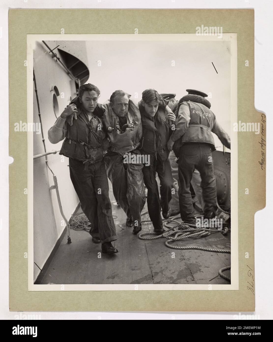 Coast Guardsmen assist a German prisoner who escaped from his sinking ...