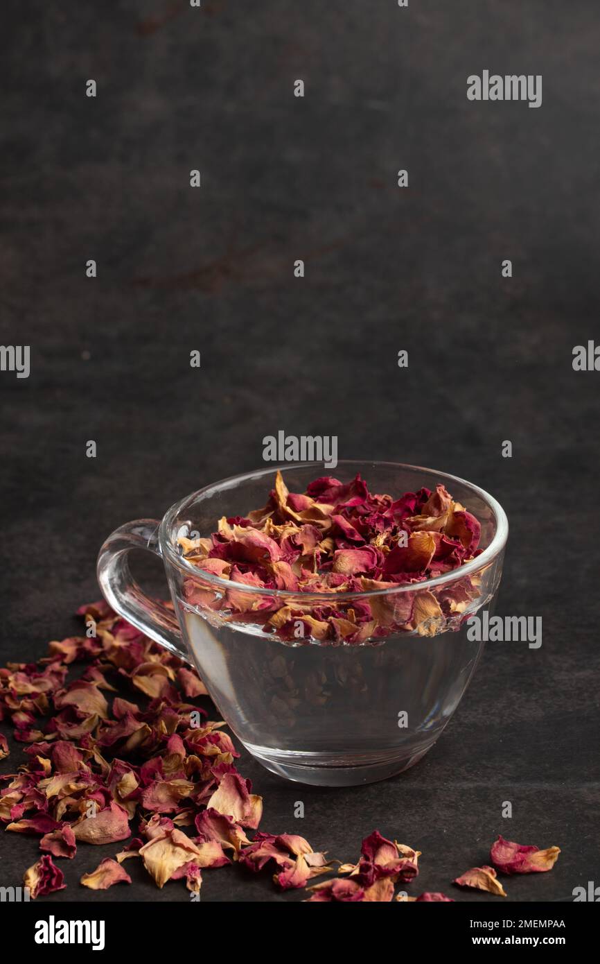 Rose tea in transparent glass on black background Stock Photo - Alamy