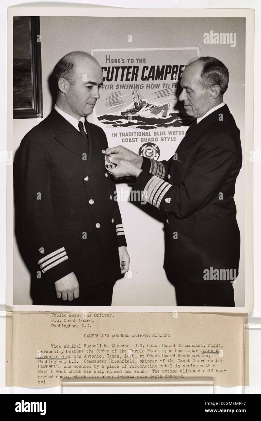 Vice Admiral Russell R. Waesche awards the Order of the Purple Heart to ...