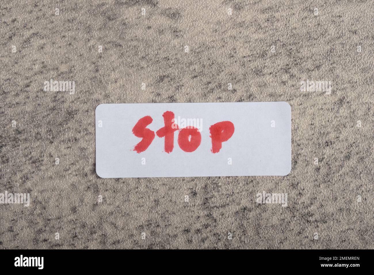 a piece of paper after writing the word 'STOP' Stock Photo - Alamy