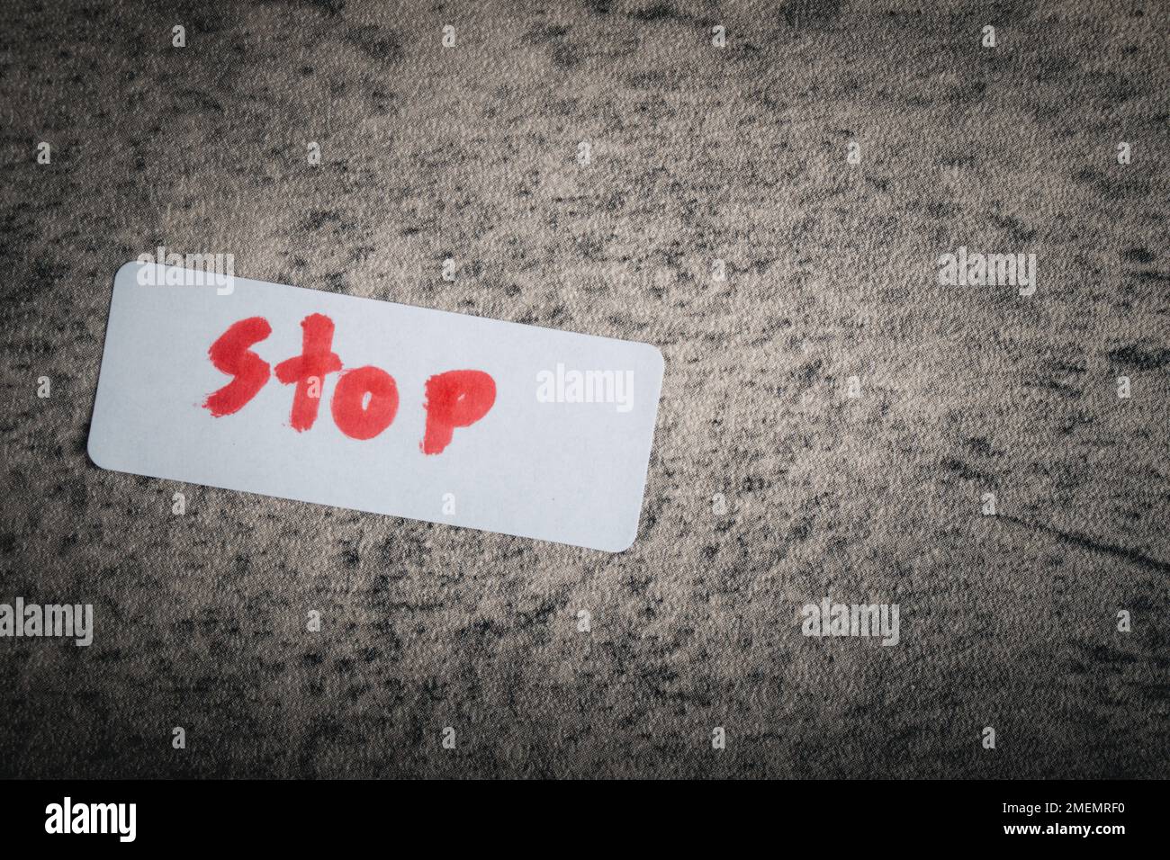 a piece of paper after writing the word 'STOP' Stock Photo - Alamy