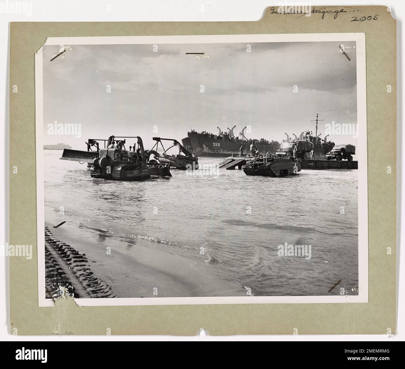 This photograph shows U.S. Coast Guard personnel unloading bulldozers ...