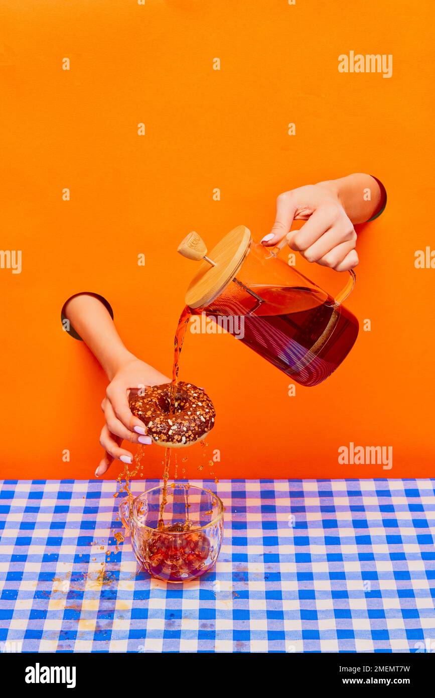Food pop art photography. Female hand sticking out orange paper with ...