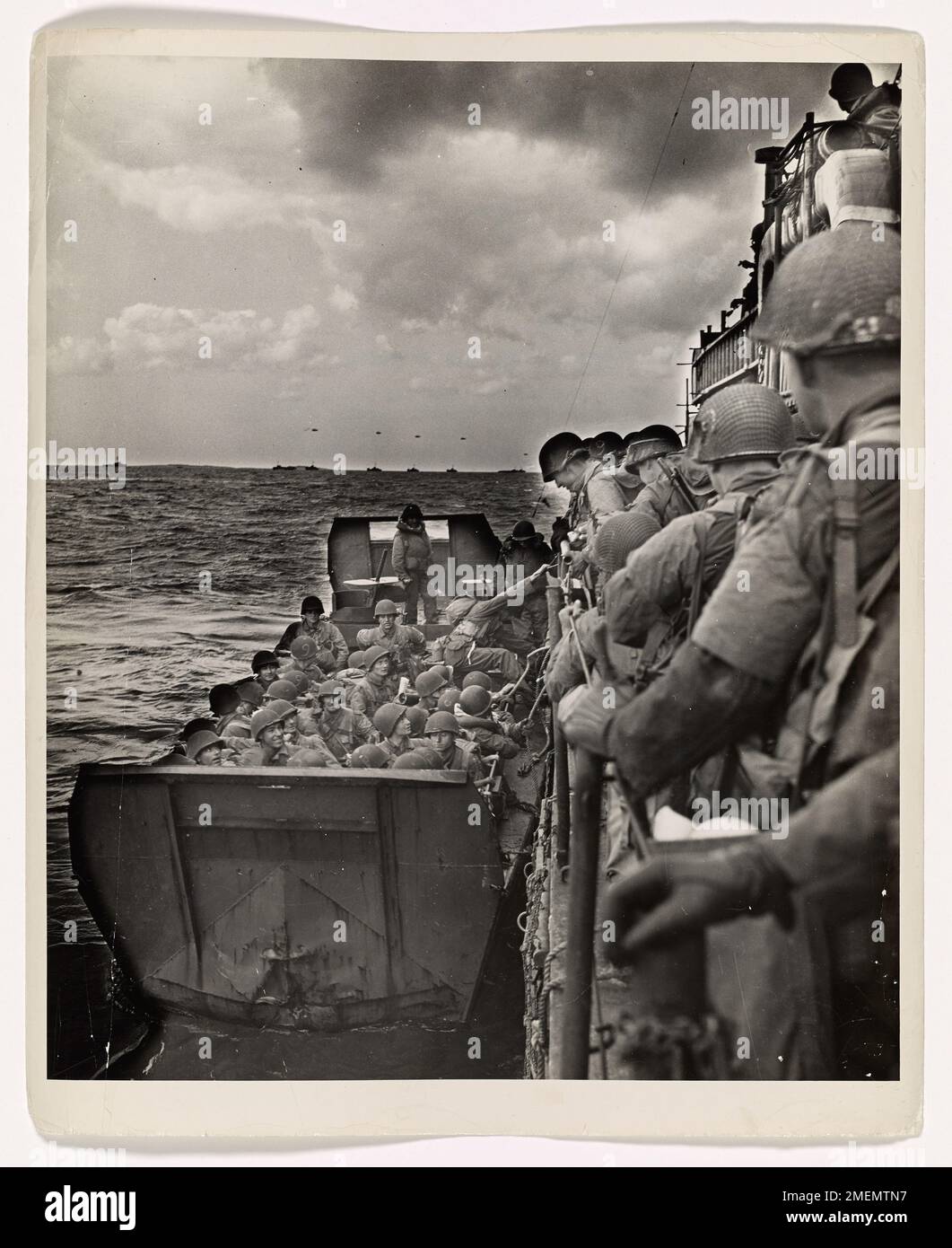 American forces transfer from a Coast Guard LCI to a landing barge ...