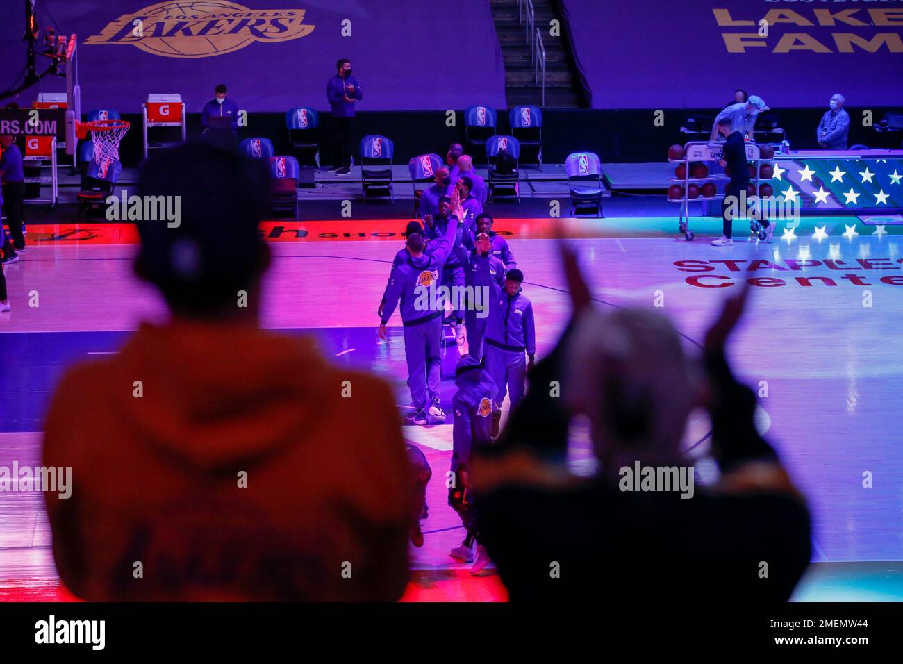Los Angeles Lakers fans stand for their team before an NBA basketball ...