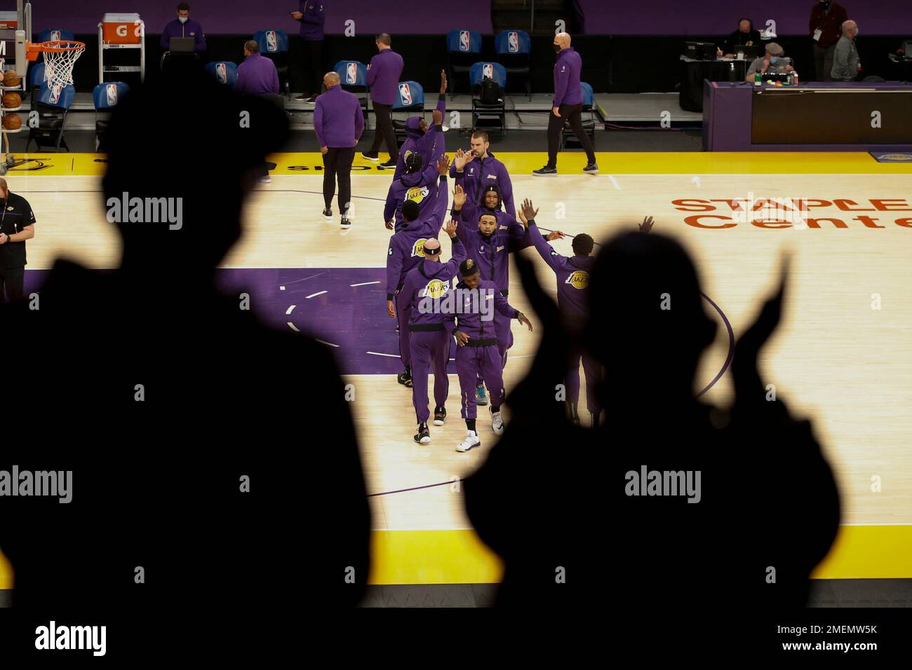 Los Angeles Lakers fans stand for their team before an NBA basketball ...