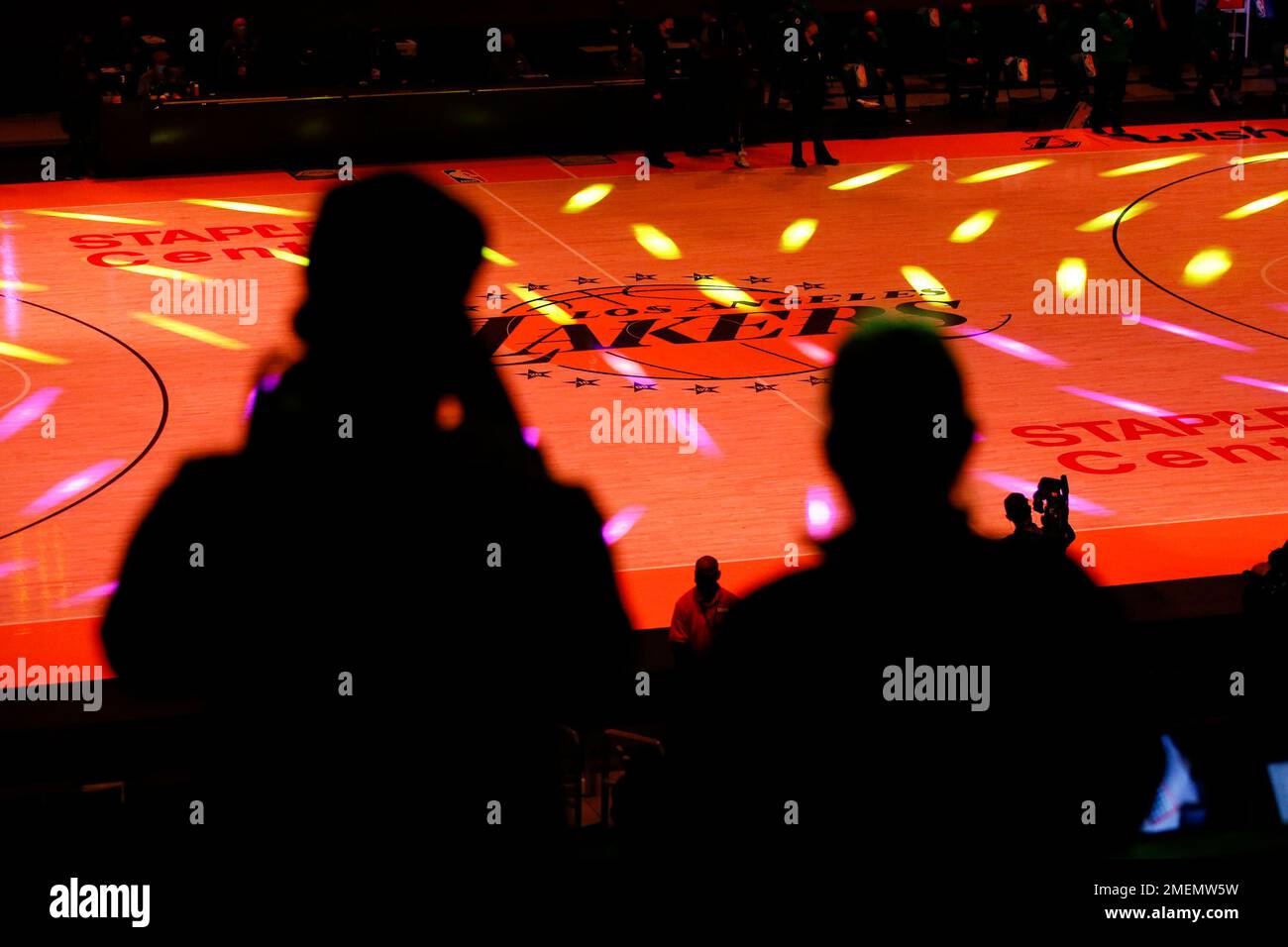 Los Angeles Lakers fans stand for their team before an NBA basketball ...