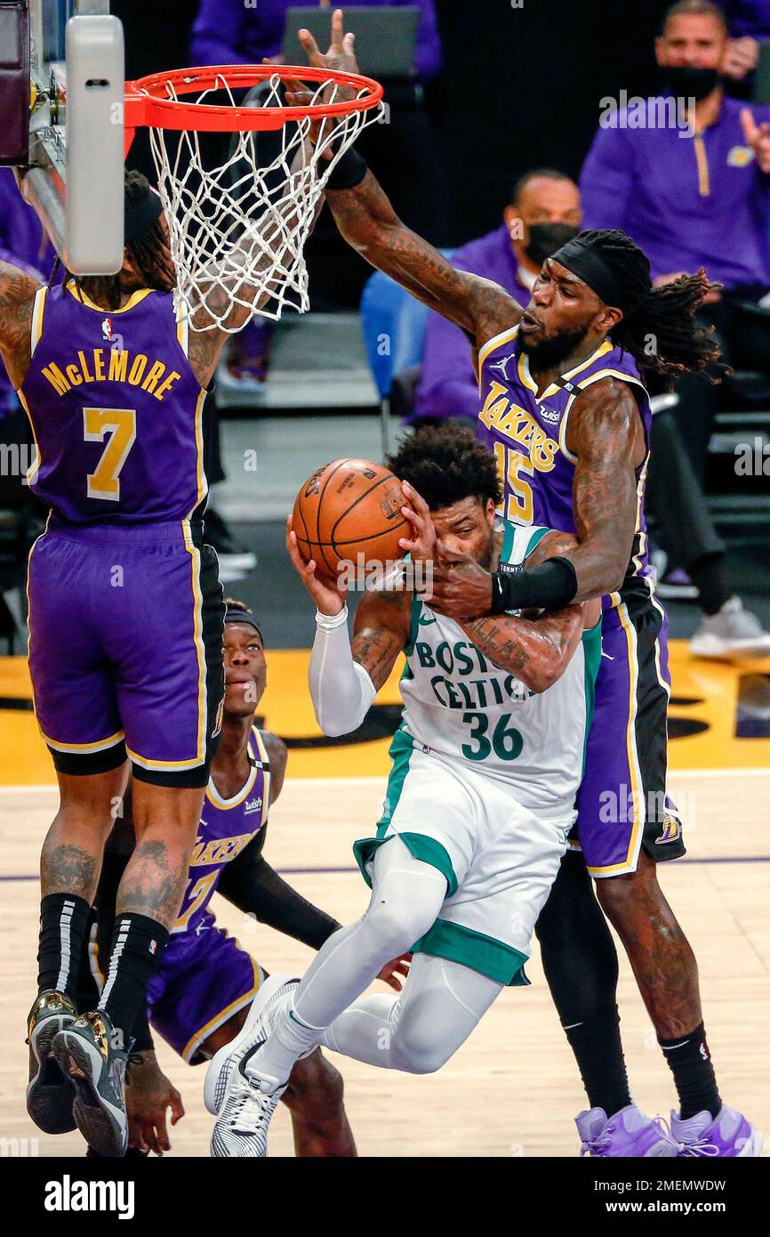 Boston Celtics' Marcus Smart (36) goes to basket under pressure from ...