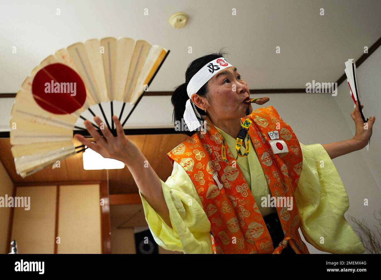 Olympic fan Kyoko Ishikawa shows her cheering at her home Saturday ...