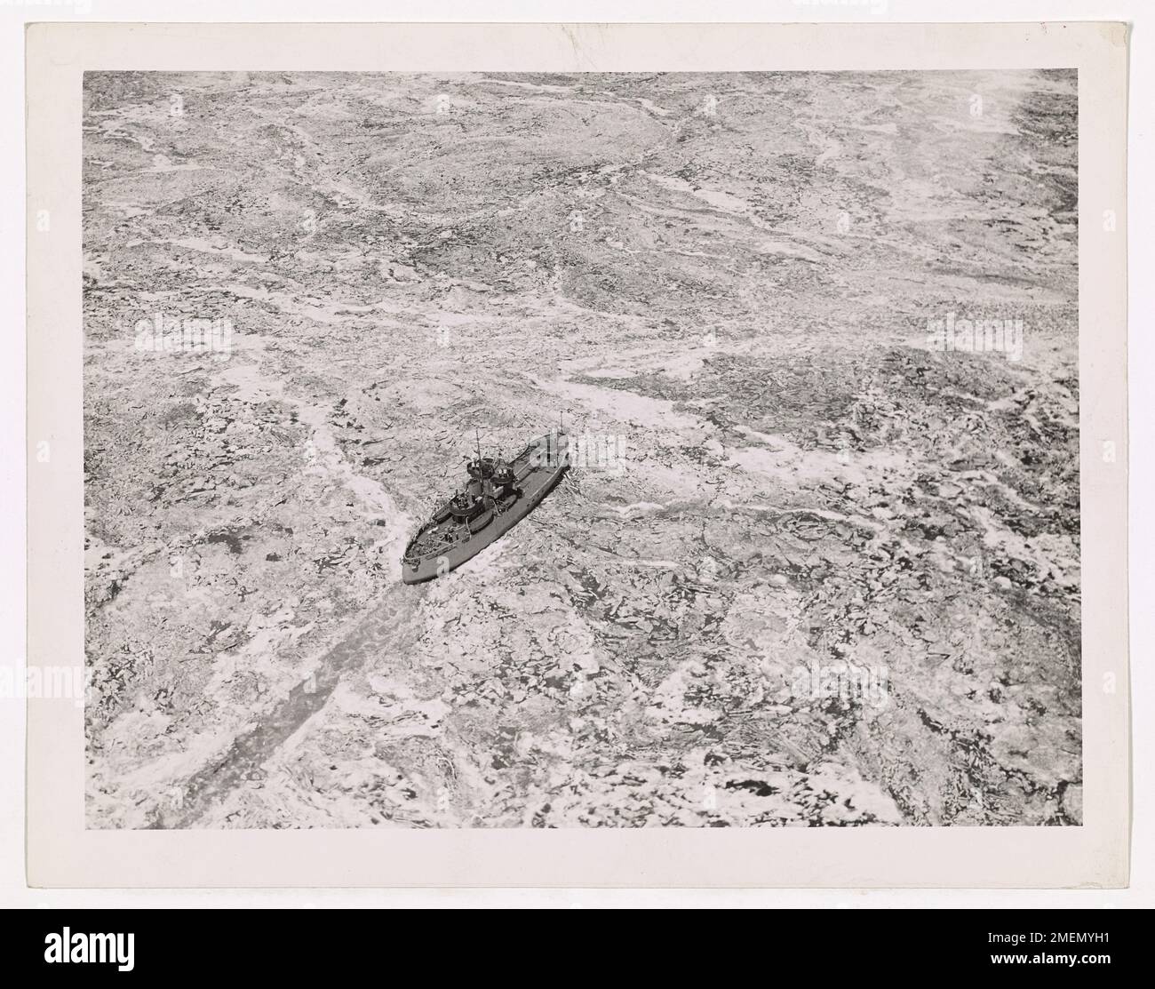 This image shows the USS Citrus engaged in ice breaking operations ...