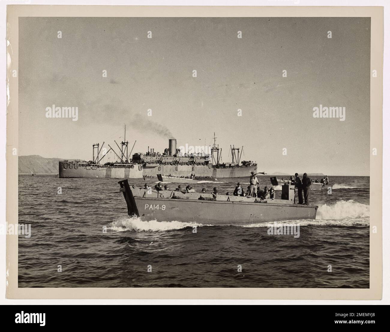 Coast Guard-manned invasion barges are shown conducting training ...